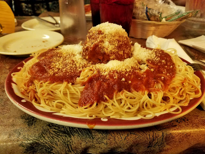 Three perfect meatballs standing proud atop a mountain of pasta. The generous dusting of Parmesan is like fresh snow on the Alps.