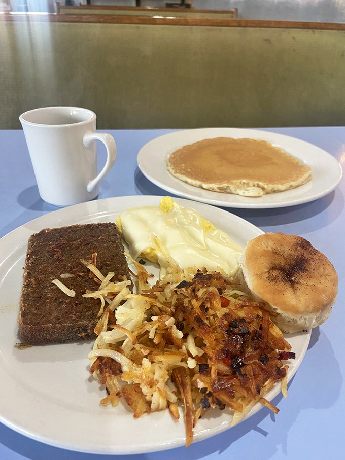 This isn't just breakfast—it's a morning symphony with crispy hash browns, eggs, and what appears to be scrapple, Delaware's contribution to breakfast excellence.