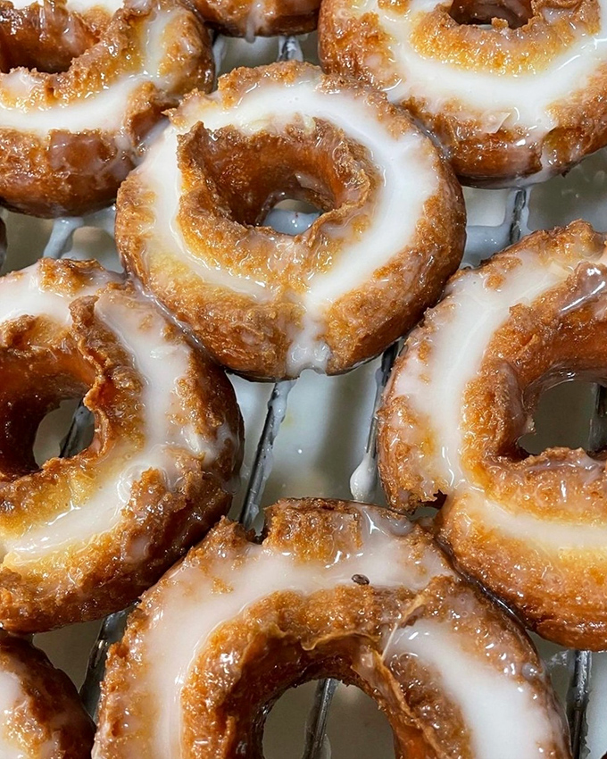Old-fashioned glazed donuts stacked like edible gold coins. That glaze catches light the way diamonds catch compliments&mdash;effortlessly and with style.