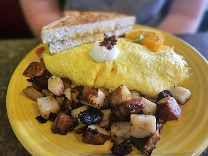 This omelet doesn't just sit on the plate&mdash;it lounges, confident in its golden perfection, while the potatoes huddle nearby plotting their delicious destiny.
