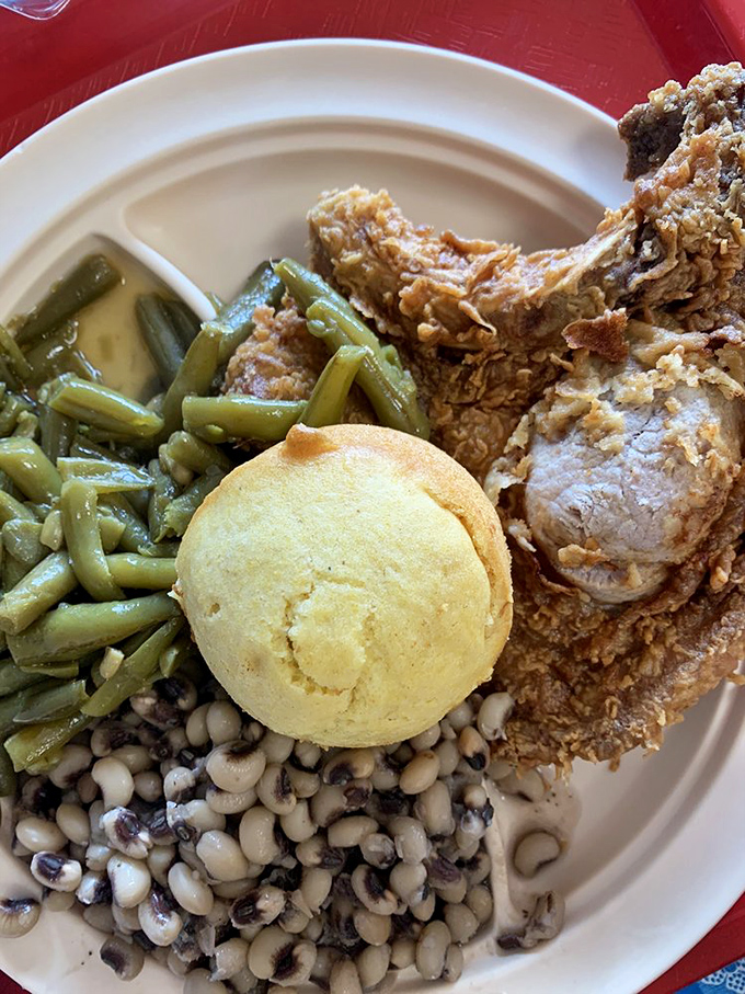 Southern harmony on a plate: crispy fried pork, tender green beans, and black-eyed peas that would make your grandma nod in approval.