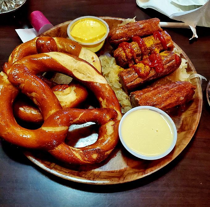 When a pretzel, bratwurst, and beer cheese share a wooden plate, they're not just food &ndash; they're a diplomatic summit of German flavors negotiating deliciousness.