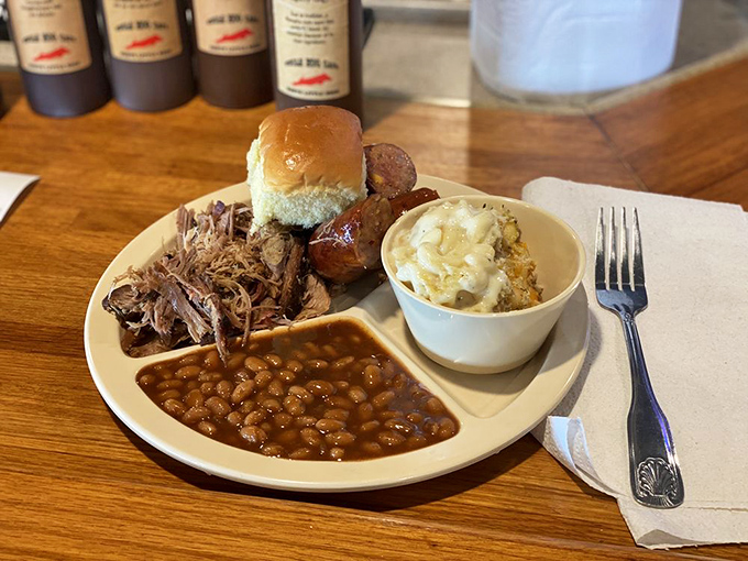 The indecision-solver: pulled pork and sausage sharing a plate like old friends, with potato salad and beans completing this holy trinity of BBQ delight.