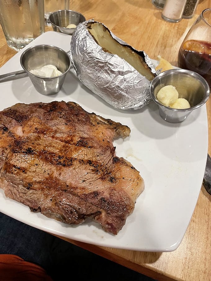 This perfectly seared ribeye with its foil-wrapped potato companion is what meat dreams are made of. Simplicity, elevated to an art form.
