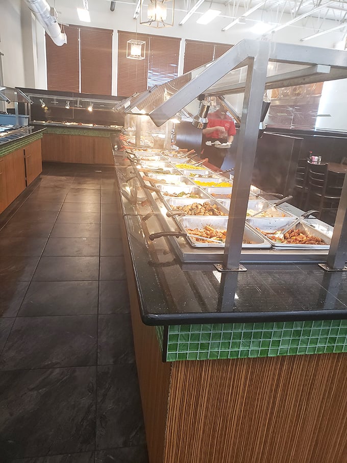 The buffet stretches into the distance like a culinary yellow brick road, each tray offering another temptation on your journey to fullness.