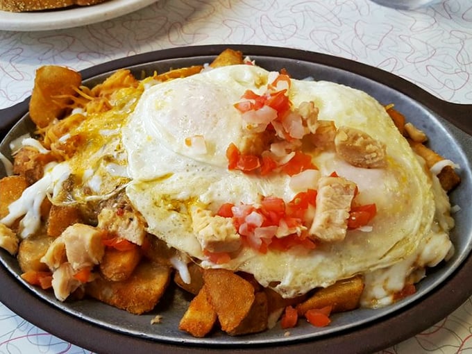Breakfast ambition realized: a sizzling skillet loaded with potatoes, eggs, and enough toppings to make your cardiologist wince but your soul sing.