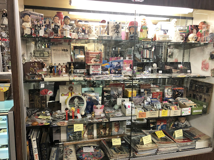 Behind glass, memories are cataloged and priced&mdash;baseball cards, figurines, and vinyl records waiting to trigger someone's "I had that!" moment. 