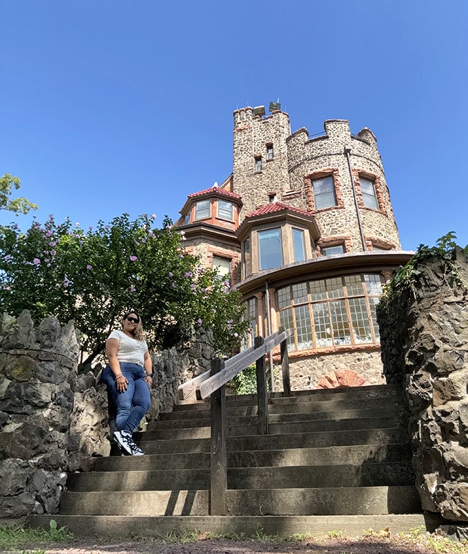 The castle's impressive stone facade provides the perfect backdrop for visitors ascending the steps toward their own royal adventure.
