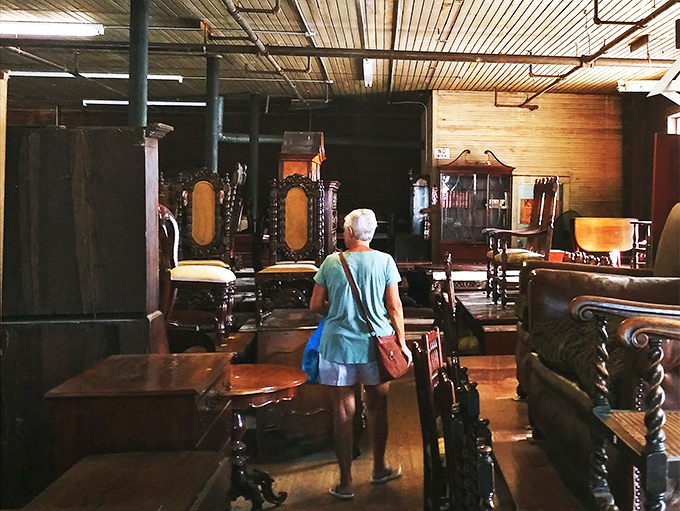 The universal antiquing stance: hands clasped behind back prevents the "you break it, you bought it" scenario we all dread.