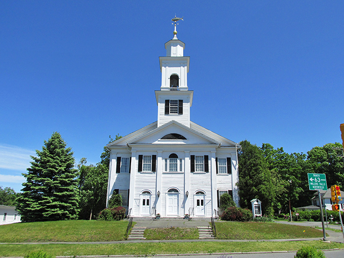 Discover the timeless beauty of Amherst as you admire this grand white church standing tall against a bright blue sky.