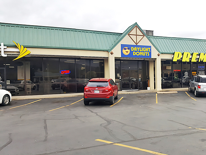 Daylight Donuts' cheerful blue sign with its smiling sun mascot knows exactly what time it is &ndash; donut o'clock!