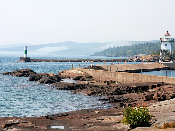 Grand Marais harbor welcomes you with its iconic lighthouse—where Lake Superior's moods change hourly but the charm remains constant.