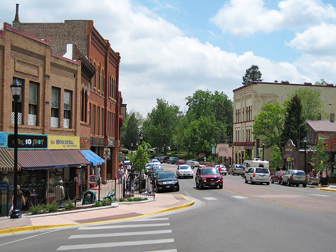 Historic storefronts line the sunny streets of Manitou Springs, where you can explore local shops and enjoy a peaceful afternoon.
