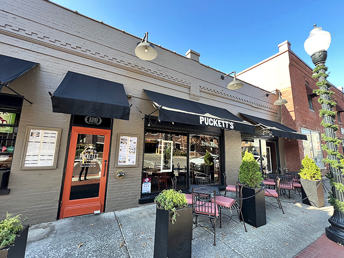 Puckett's storefront whispers tales of small-town charm and big-time flavors. Those black awnings have sheltered many happy diners!