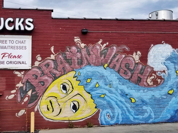 Shucks' playful fish mural splashes across the brick wall - a colorful preview of the ocean flavors waiting inside.