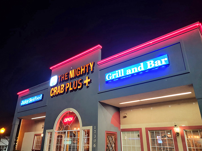 The Mighty Crab's neon glow cuts through the night like a lighthouse, guiding hungry travelers to seafood salvation.