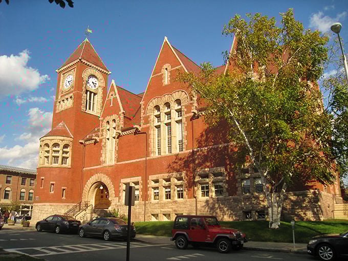 Admire the striking red brick architecture of this historic building as you explore the vibrant heart of downtown Amherst.