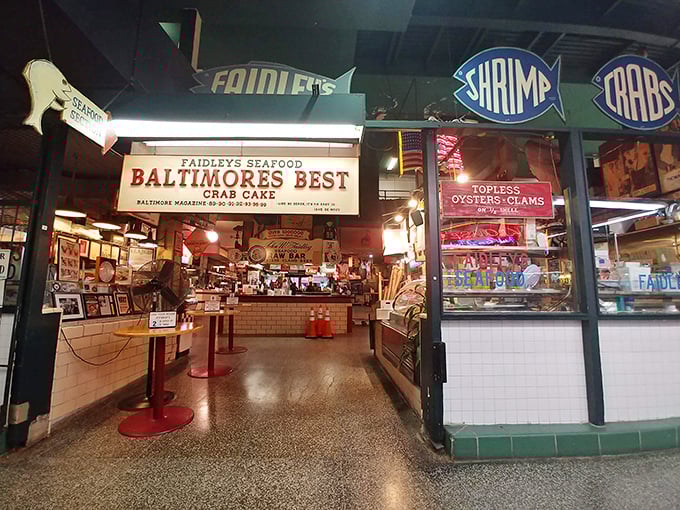 The neon signs aren't just decoration&mdash;they're beacons guiding you to crab cake nirvana in Lexington Market's bustling heart.