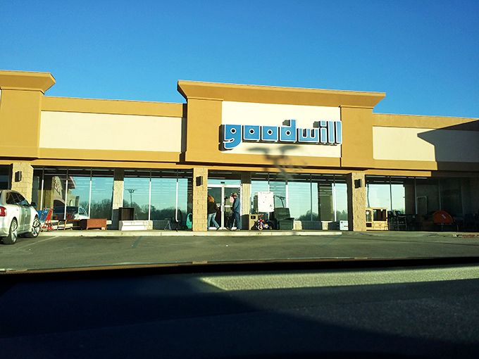 Morning light catches Goodwill's storefront, where inside, someone's discards are about to become someone else's discoveries.