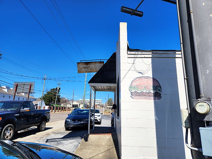The hand-painted burger on the wall is like a bat signal for hungry people – a beacon of hope in a world of disappointing fast food.
