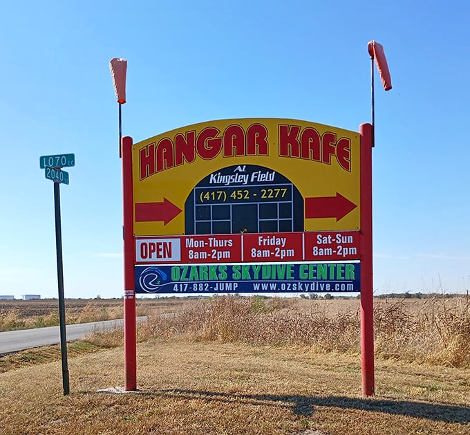 The bright yellow sign for Hangar Kafe stands out against the Missouri sky, guiding hungry pilots and road-trippers alike to breakfast paradise.