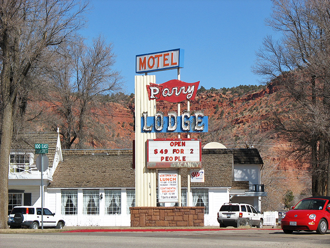 The Perry Lodge sign stands as a cheerful sentinel against Kanab's dramatic red rock backdrop.