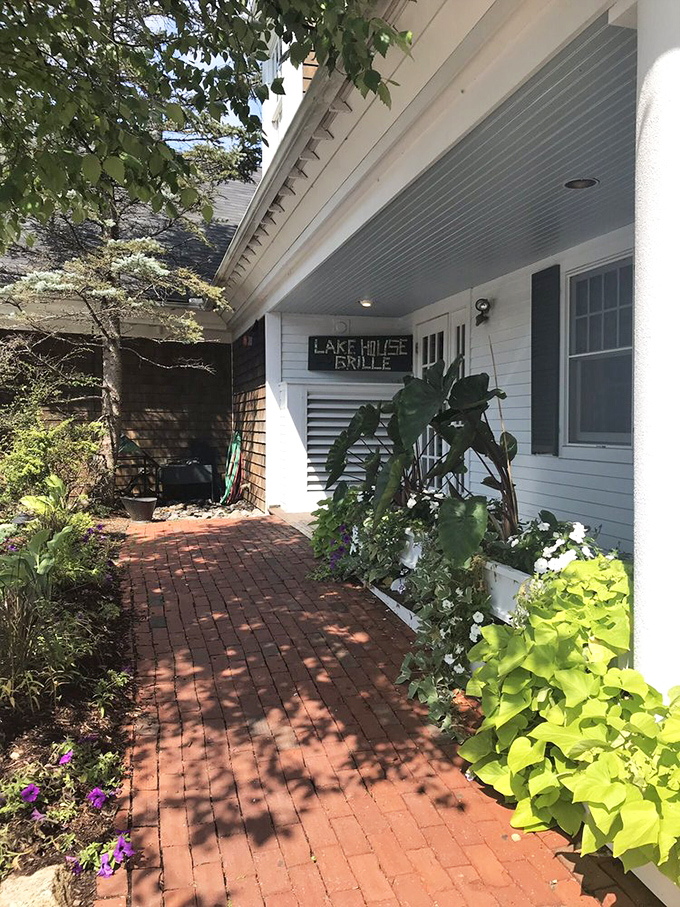 The lush garden path leading to Lakehouse Grille&mdash;where every flower seems to whisper, "The prime rib is exceptional today."
