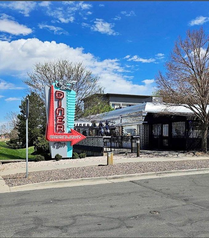 That silver diner entrance whispers sweet promises of hash browns and nostalgia in equal, delicious portions.