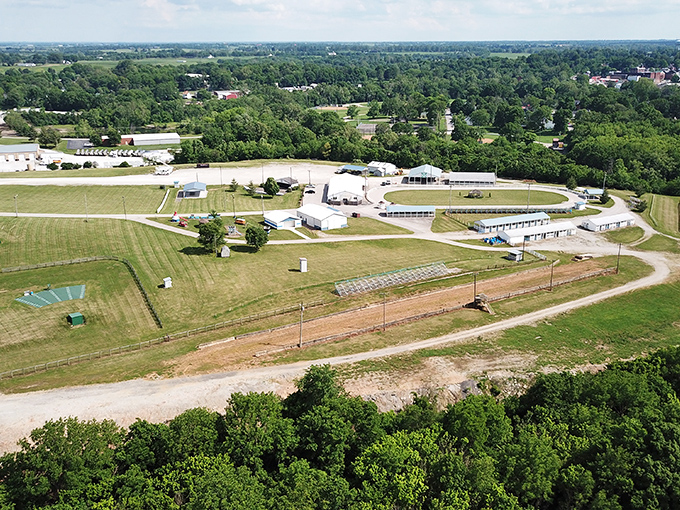 Lush green fields and community fairgrounds await you in this peaceful aerial view overlooking the charming town of Paris today.