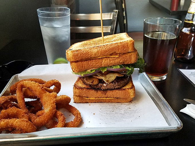 Who needs a traditional bun when Texas toast can cradle your burger? Those onion rings aren't just a side—they're a golden, crispy halo of happiness.
