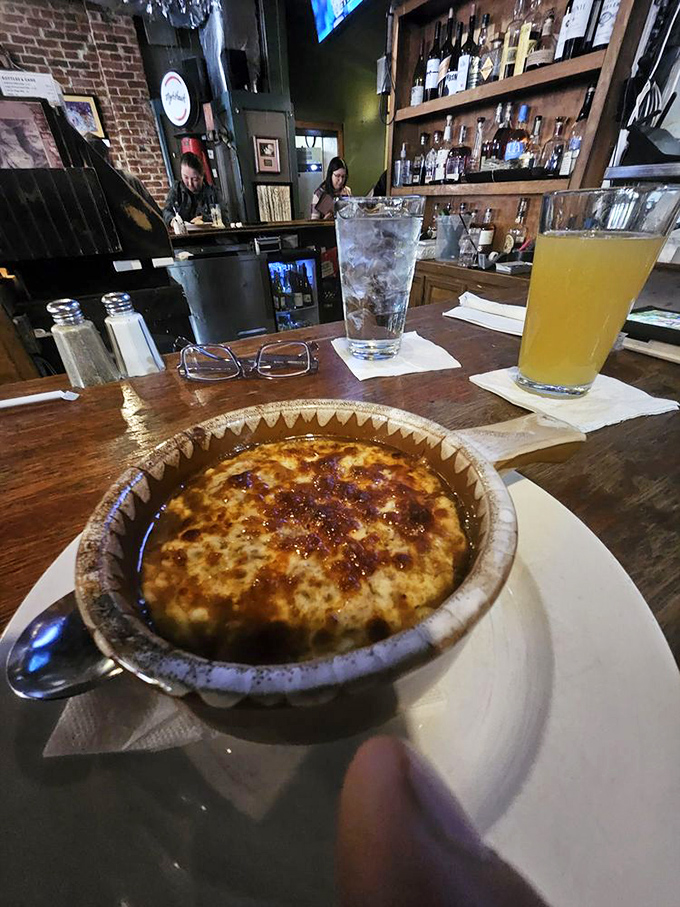 Bar-side bliss with that famous French onion soup. Notice how everyone around seems happier just being in its presence?