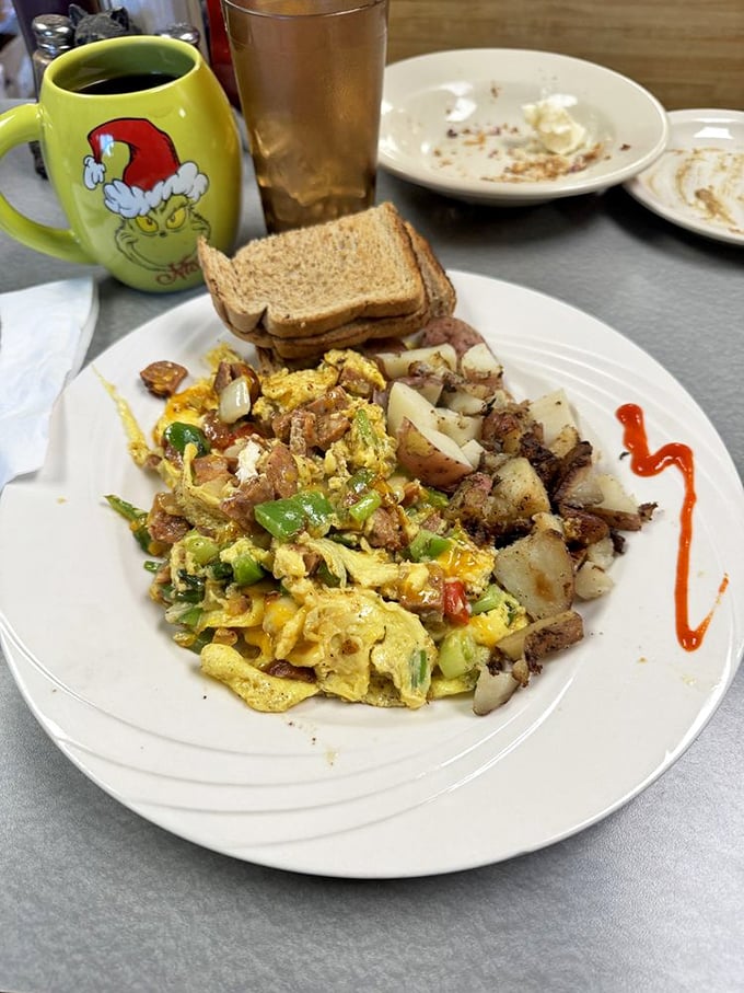 A scramble that means business – vibrant veggies, savory sausage, and fluffy eggs create a colorful canvas of flavors. The home fries are the unsung heroes here.