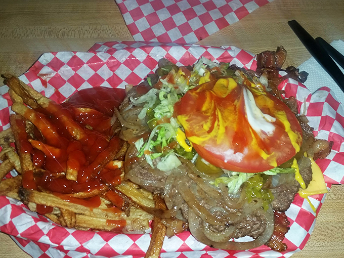 Fries with attitude and a burger that means business. The red-checkered paper is both your plate and your napkin—you'll need it.