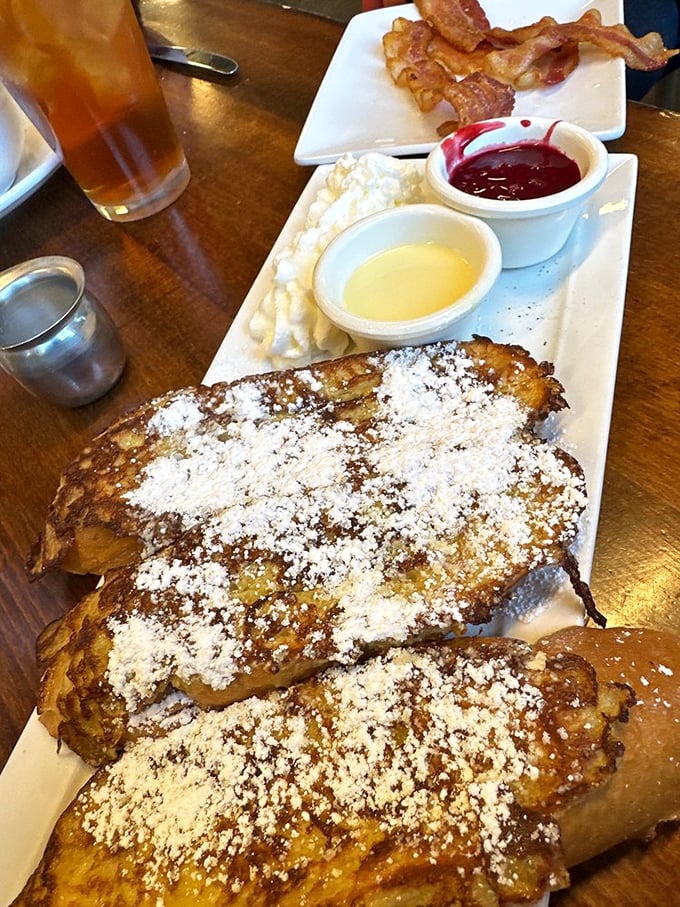 French toast that makes you question every other breakfast you've ever had. The powdered sugar snowfall is just showing off.