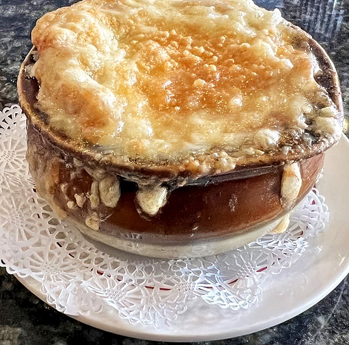 Not all heroes wear capes, but all great French onion soups wear a golden crown of bubbling cheese that's worth every delicious calorie.