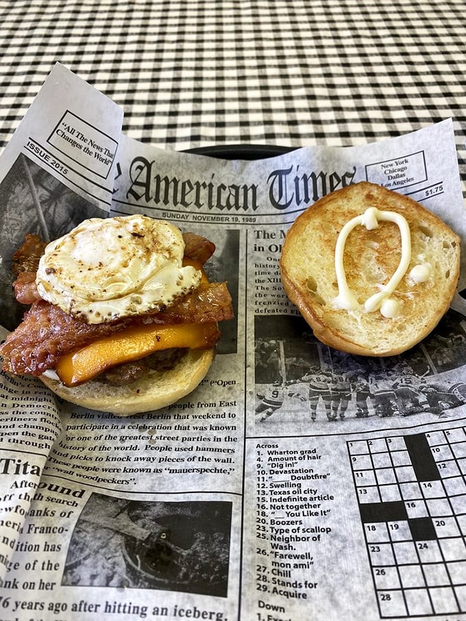 The newspaper isn't just for reading&mdash;it's the perfect stage for this breakfast burger masterpiece. That egg is living its best life.