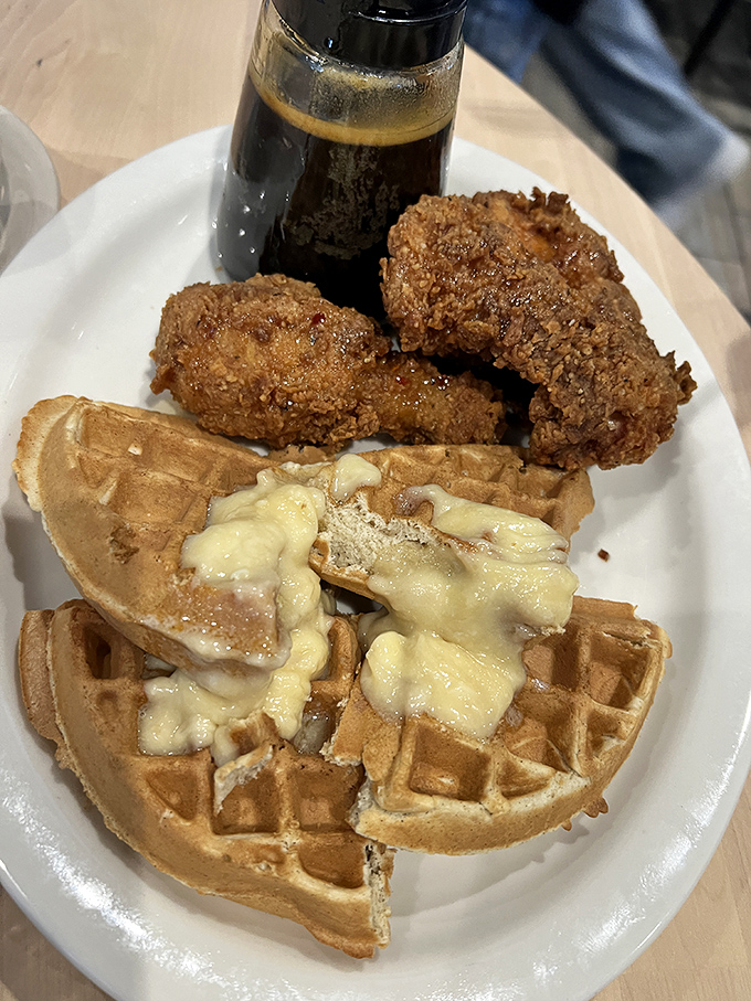 The perfect bite awaits: a forkful of waffle, a morsel of chicken, and that maple syrup bringing it all together. Some marriages are made in heaven; this one was made in Wichita.