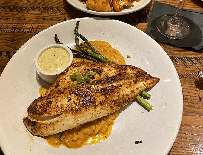 This blackened redfish perches majestically atop golden risotto – proof that Oklahoma knows seafood better than coastal snobs might expect.