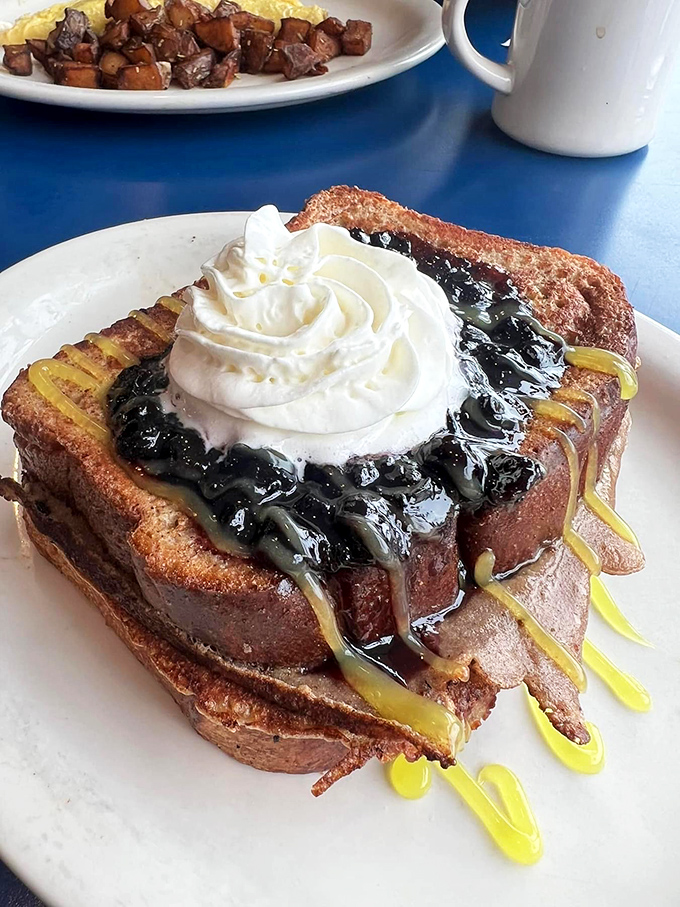 Blueberry and lemon French toast topped with whipped cream&mdash;nature's perfect flavor marriage officiating your morning happiness ceremony.