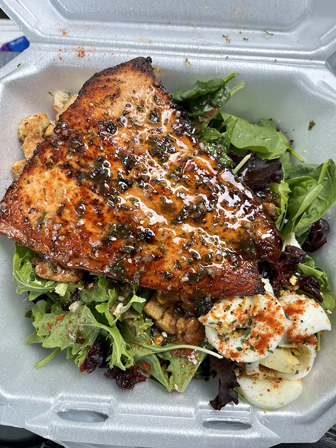 Perfectly seared salmon resting on a bed of fresh greens proves soul food isn't just about indulgence&mdash;it can have a lighter side that's equally magnificent.