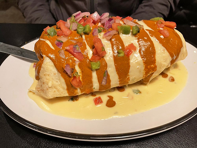 Not your average burrito &ndash; this tortilla-wrapped masterpiece comes dressed for success with chili, cheese, and enough fresh toppings to require a knife and fork.