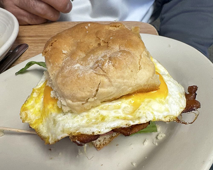 Breakfast architecture at its finest&mdash;a perfectly fried egg perched atop bacon on a biscuit that could make a Southern grandma nod in approval.