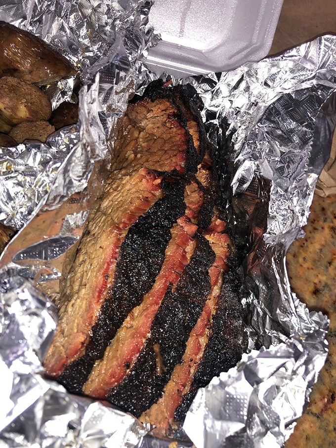 Behold the brisket in its natural habitat&mdash;glistening with juices, wrapped in foil, ready to make your day infinitely better.