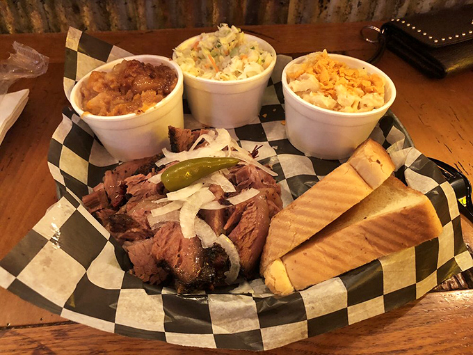 The black-and-white checkered paper doesn't just hold food—it frames edible art. Three sides because choosing just two would be unnecessarily cruel to yourself.