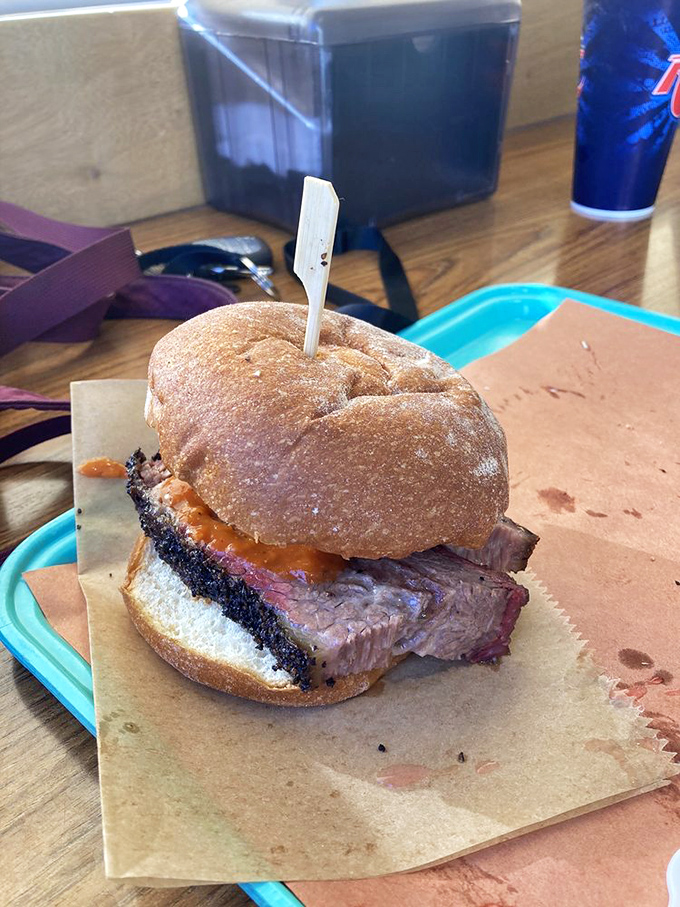 This isn't just a sandwich; it's architecture. The foundation: fresh bread. The masterpiece: perfectly smoked brisket with a bark that means business. 