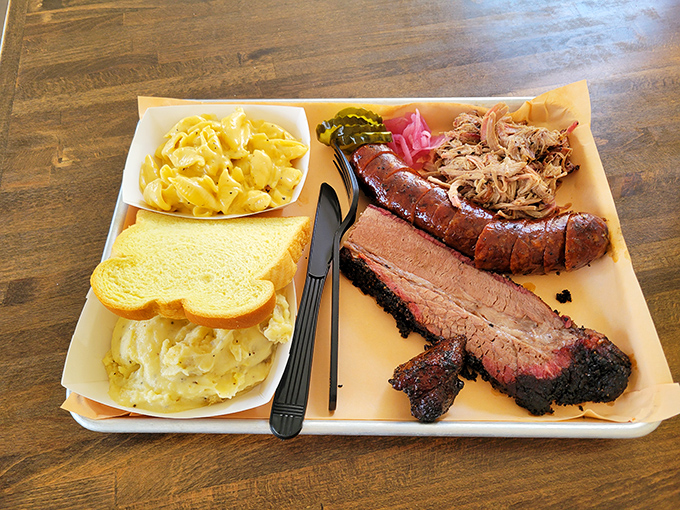 This tray is basically the United Nations of barbecue diplomacy&mdash;brisket, sausage, and pulled pork negotiating peacefully with potato salad and white bread.