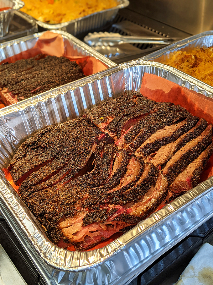 Smoke ring perfection that would make a pitmaster blush. This brisket has spent more quality time with oak wood than most people spend with their families.