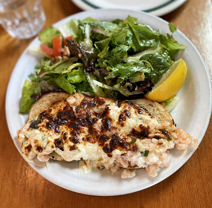 This isn't just a sandwich; it's a coastal romance&mdash;broiled shrimp nestled under melted cheese with a crisp salad playing wingman.