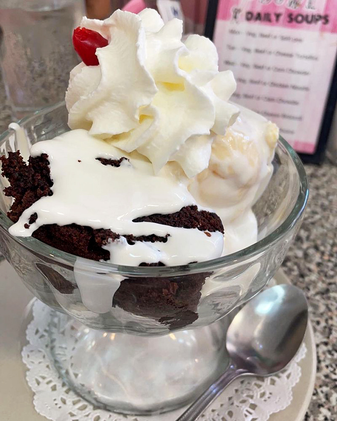 Brownie sundae nirvana: where warm chocolate cake meets cold vanilla ice cream in a temperature tango that dances straight to your soul.