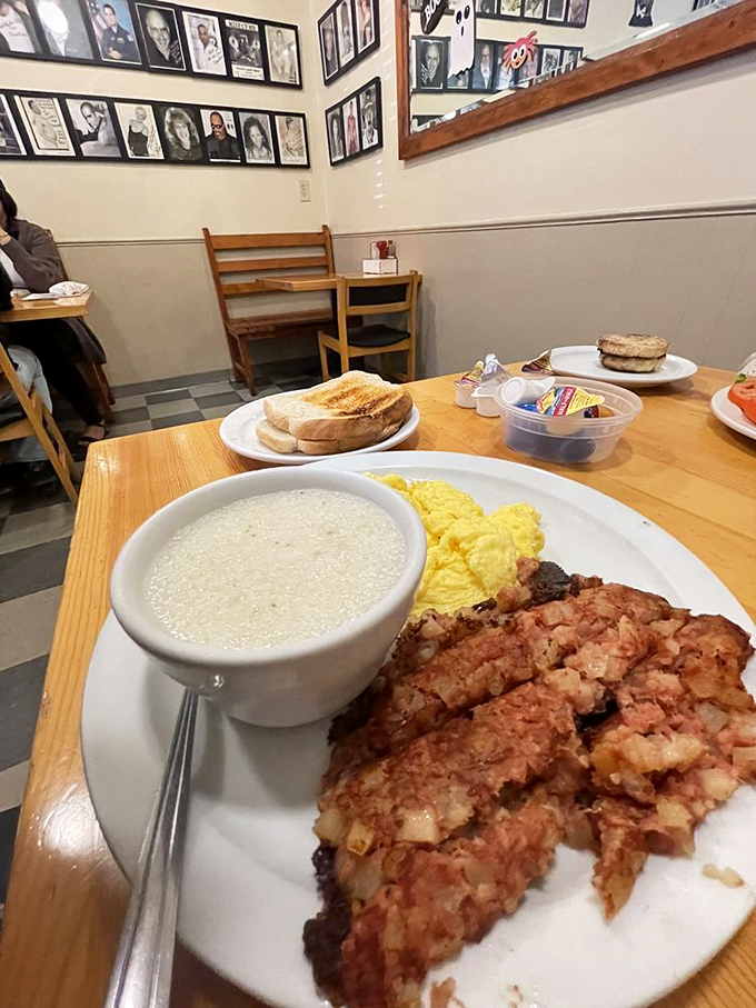 A breakfast plate that speaks the universal language of comfort &ndash; fluffy scrambled eggs, crispy hash browns, and toast ready for jam application.